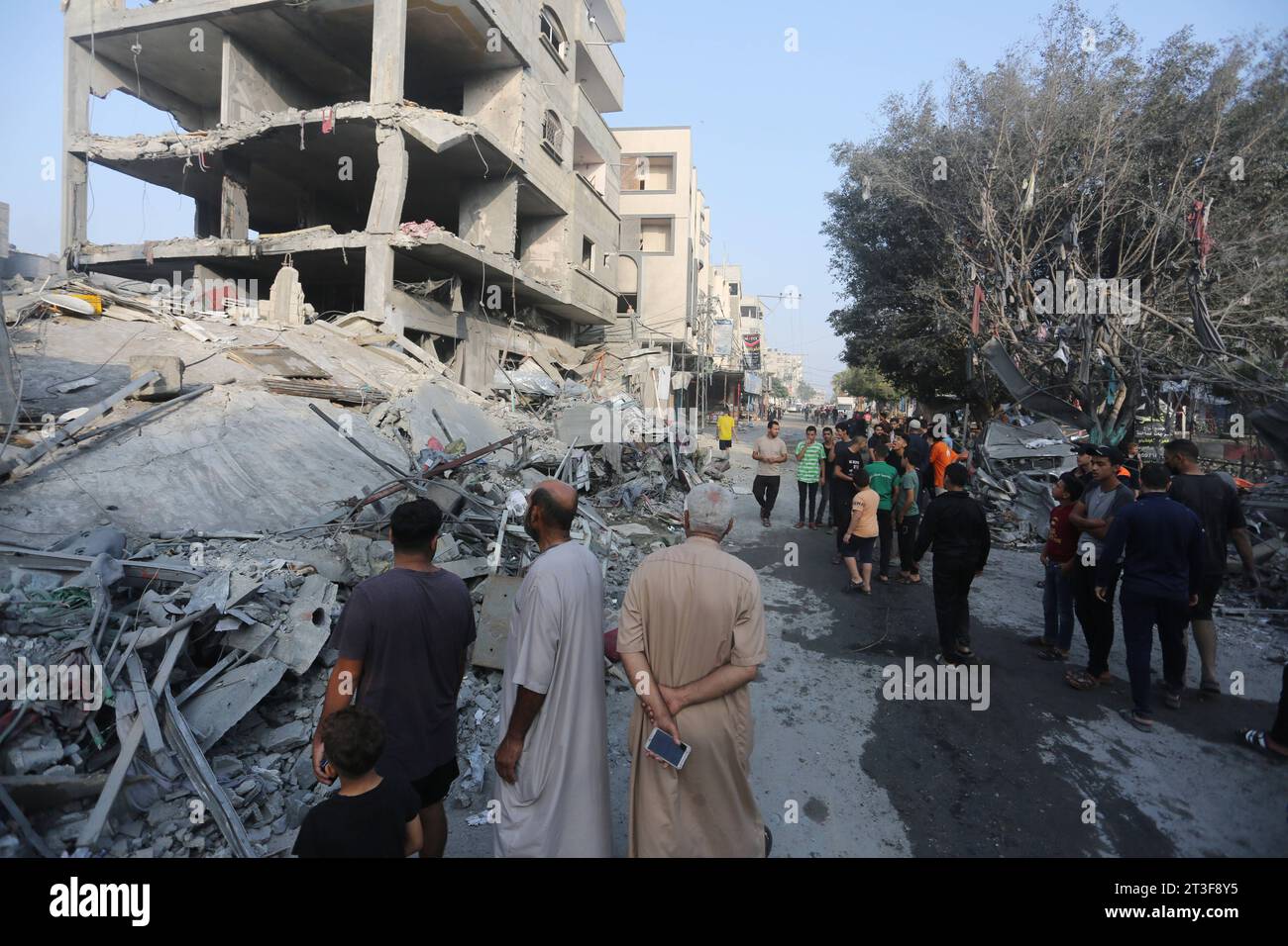Palestinians inspect the rubble of a building following overnight ...