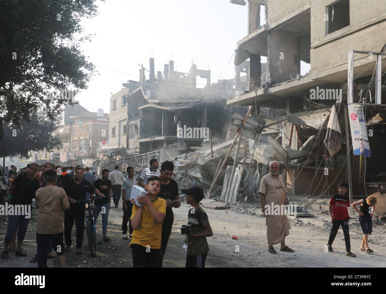 Palestinians inspect the rubble of a building following overnight ...