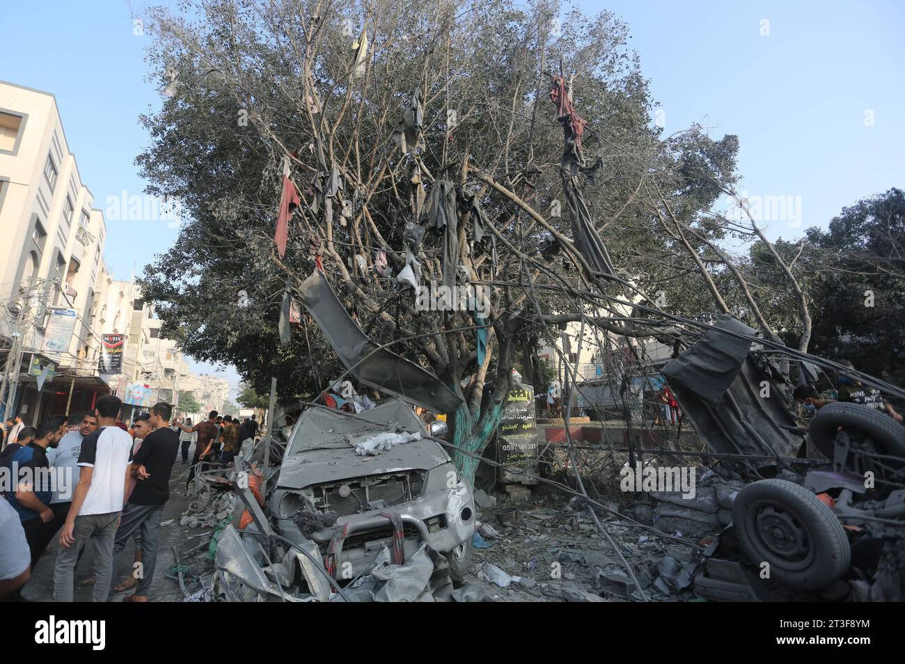 Palestinians inspect the rubble of a building following overnight ...