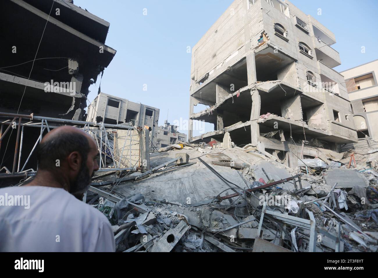 Palestinians inspect the rubble of a building following overnight ...