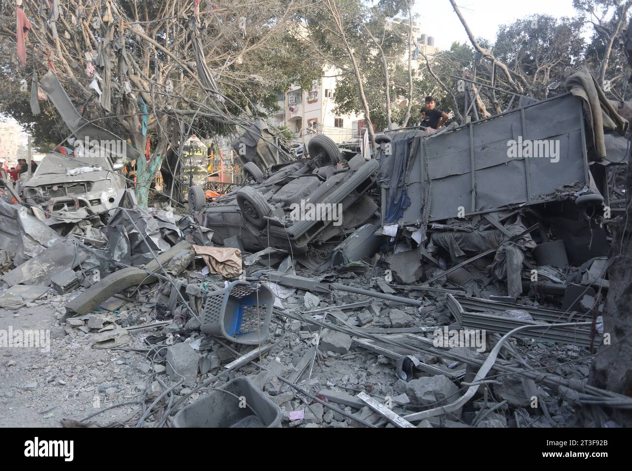 Palestinians inspect the rubble of a building following overnight ...