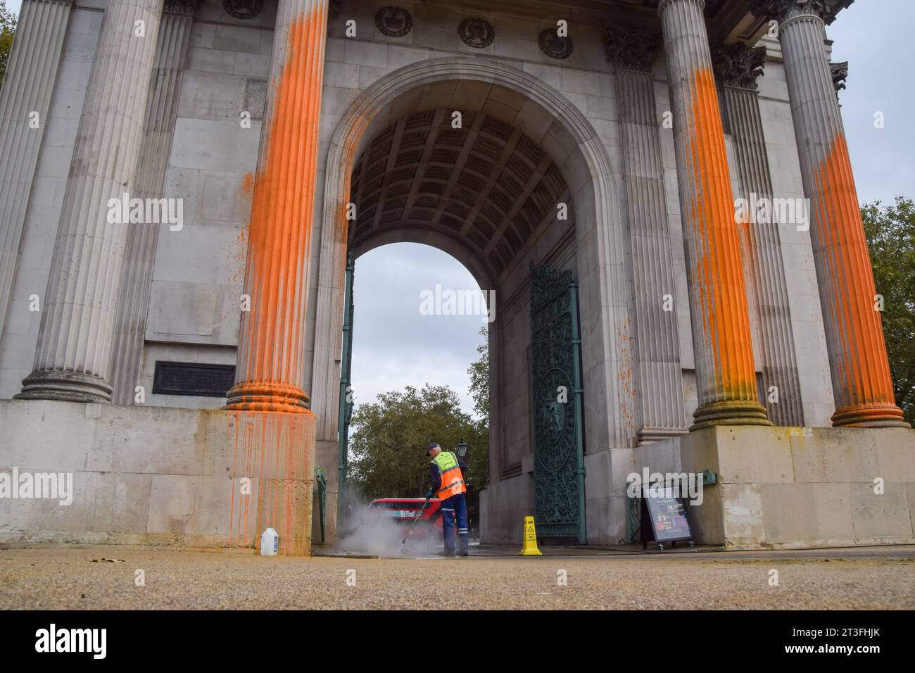 London, England, UK. 25th Oct, 2023. A worker cleans the orange paint ...