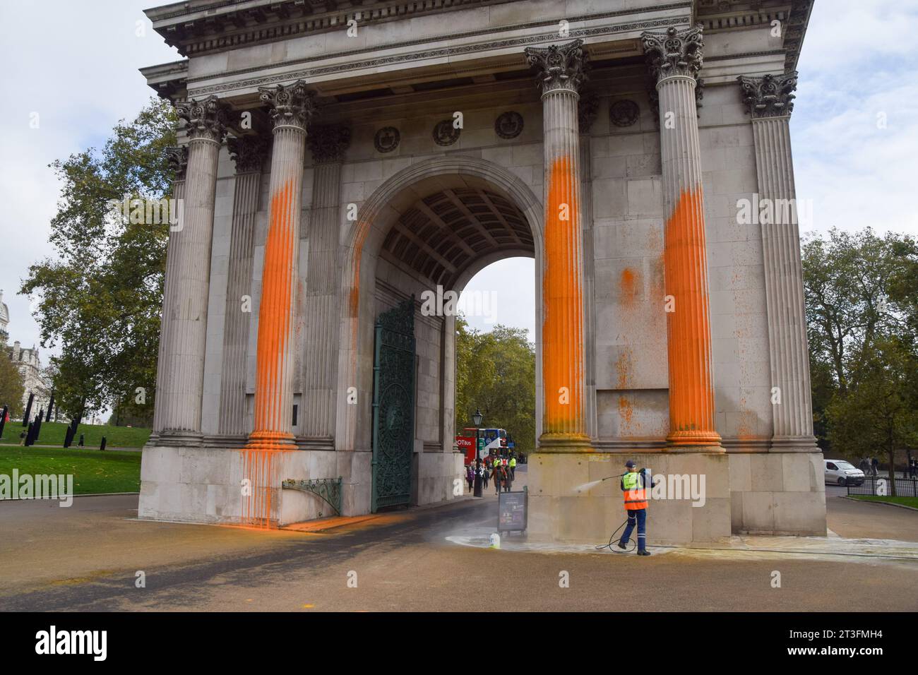 London, England, UK. 25th Oct, 2023. A worker cleans the orange paint ...
