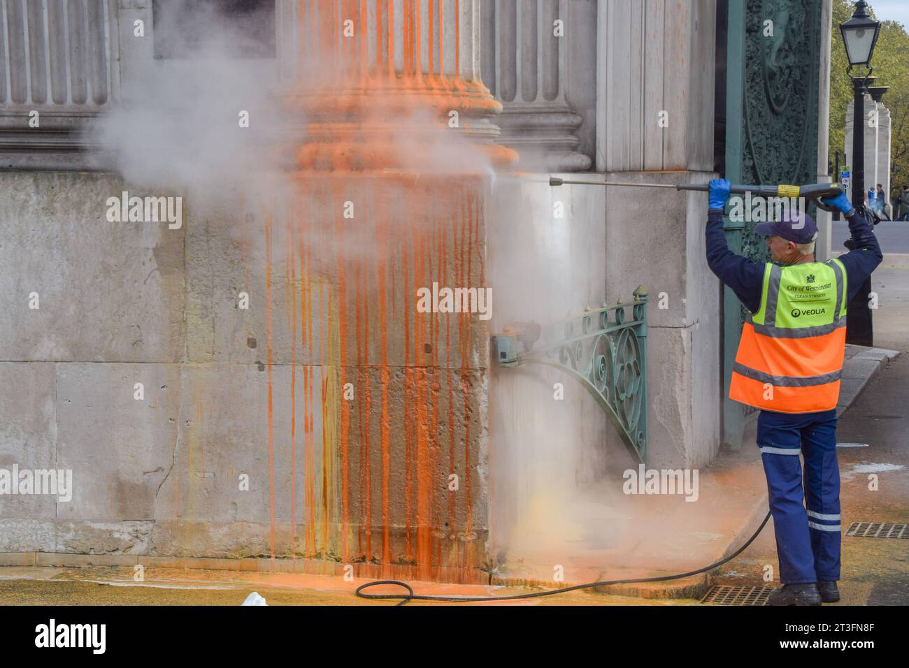 London, England, UK. 25th Oct, 2023. A worker cleans the orange paint ...
