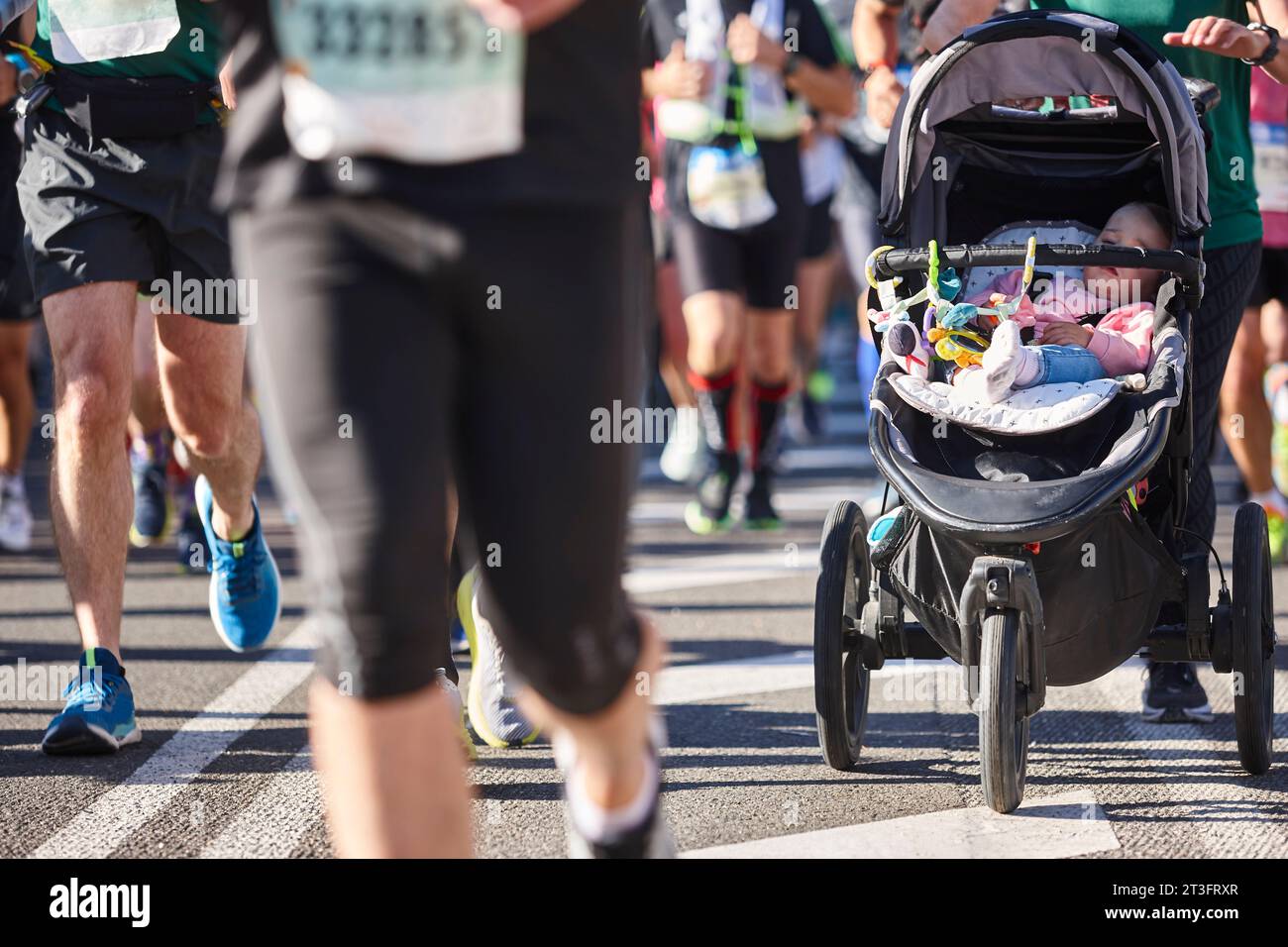 Runners and baby on the street. Healthy lifestyle. Active people Stock ...