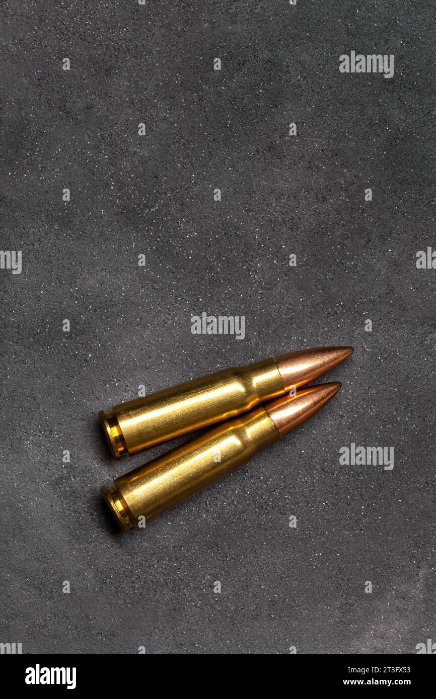 Bullets for Kalashnikov assault rifle on gray concrete background, top ...