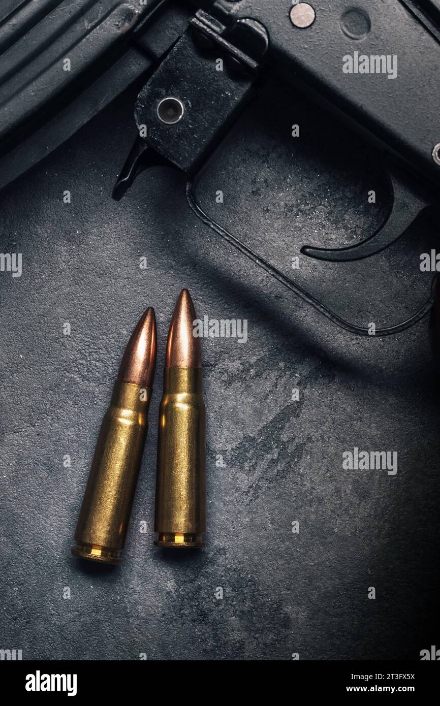 Bullets for Kalashnikov assault rifle on gray concrete background, top ...