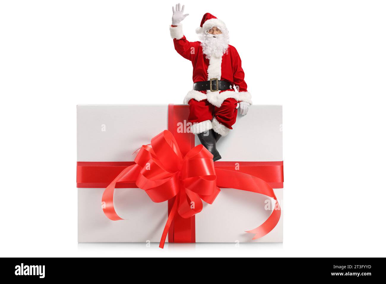 Full length portrait of santa claus sitting on a big present and waving ...