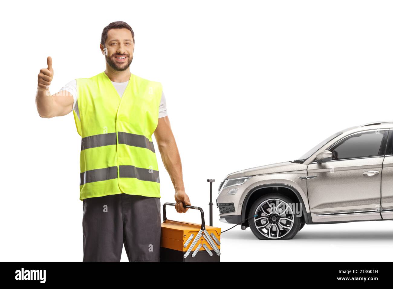 Road assistance worker holding a tool box and gesturing thumbs up in ...