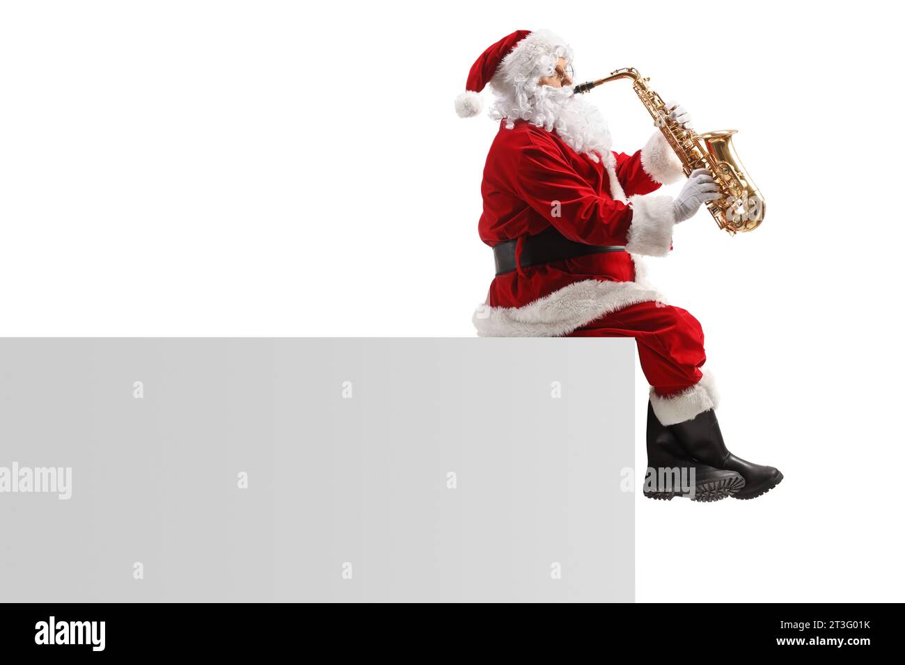 Profile shot of Santa claus sitting on a wall and playing a saxophone ...