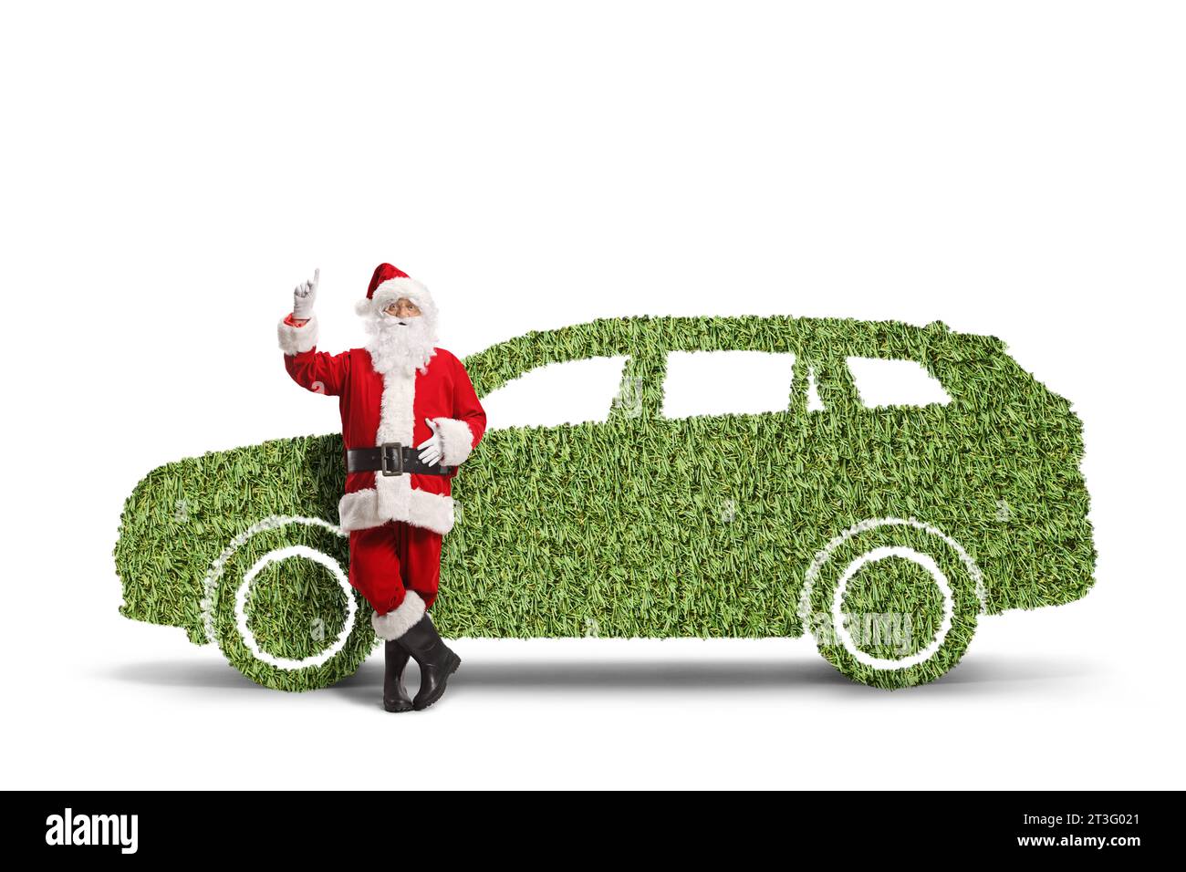 Santa claus leaning on electric SUV made of grass and pointing up ...