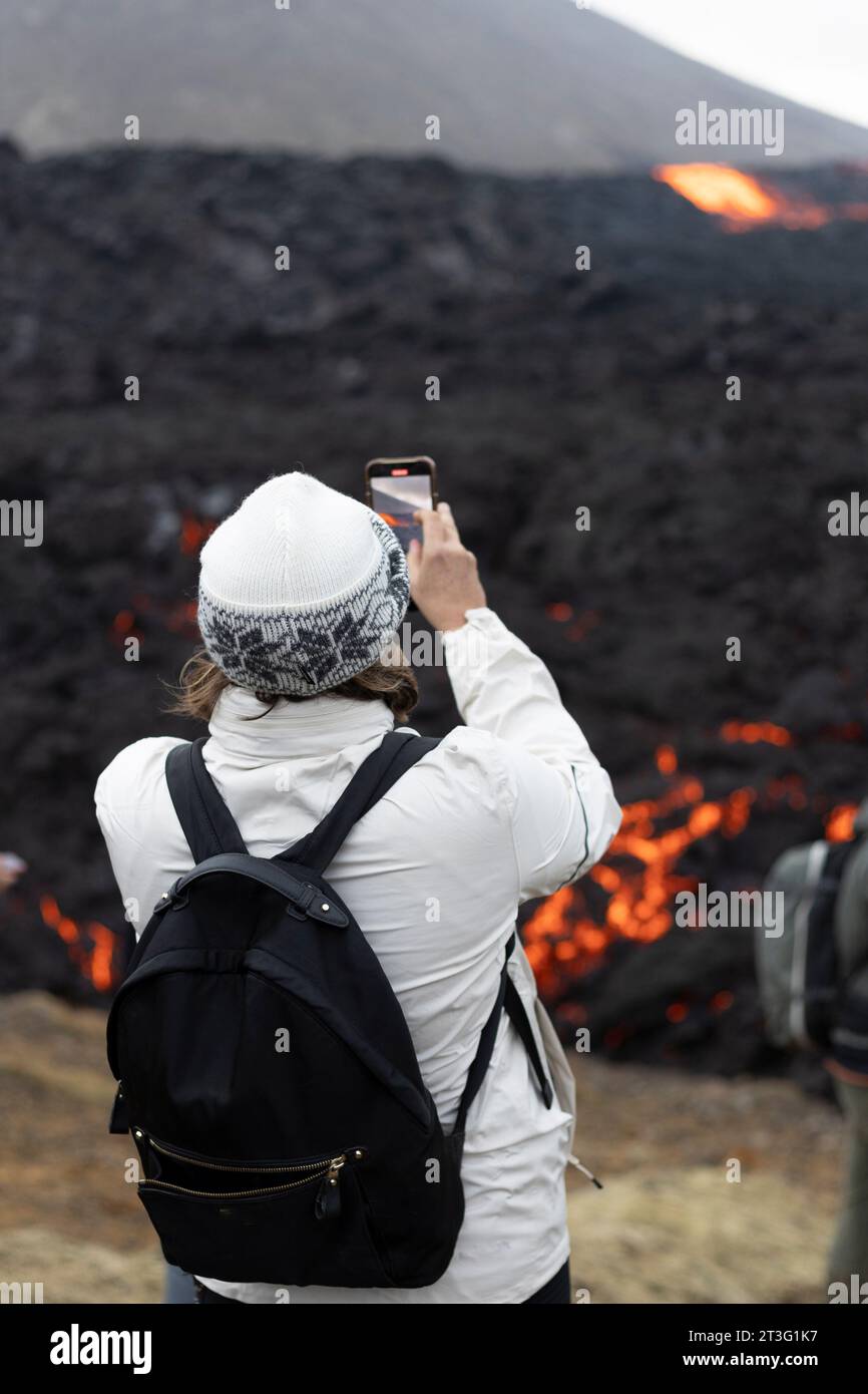 Tourist photographing volcanic eruption Stock Photo - Alamy