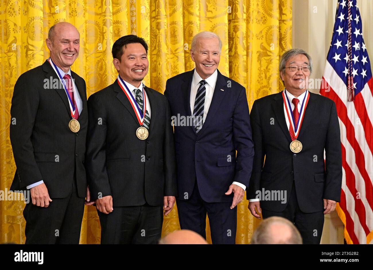 United States President Joe Biden poses for a photo with the team of ...