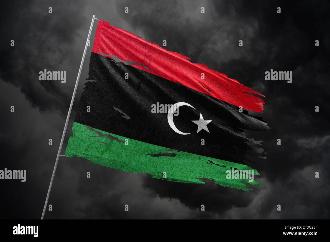 Libya torn flag on dark sky background Stock Photo - Alamy