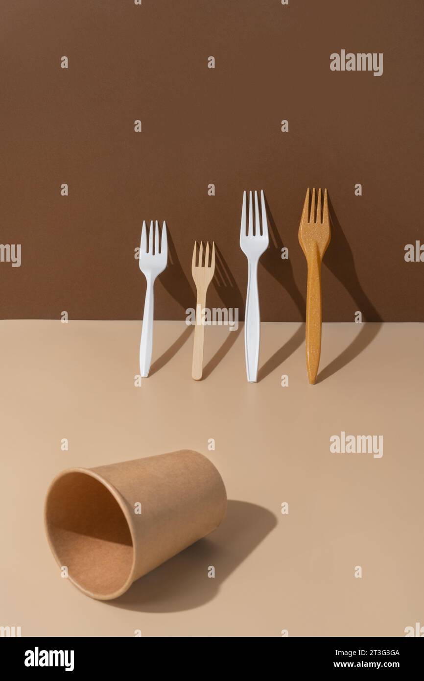 Eco friendly forks and cup on a beige and brown background Stock Photo ...