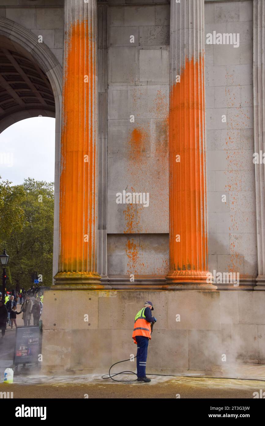 London, England, UK. 25th Oct, 2023. A worker cleans the orange paint ...