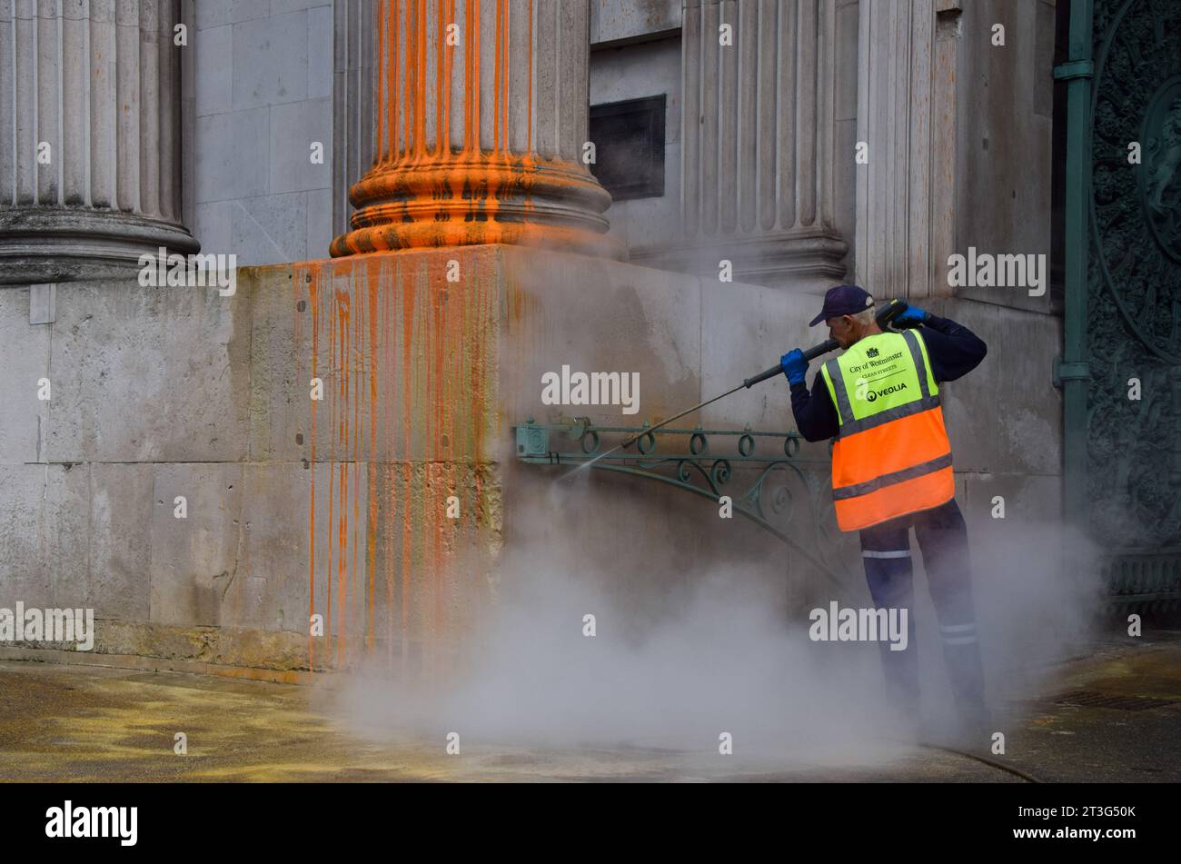 London, England, UK. 25th Oct, 2023. A worker cleans the orange paint ...