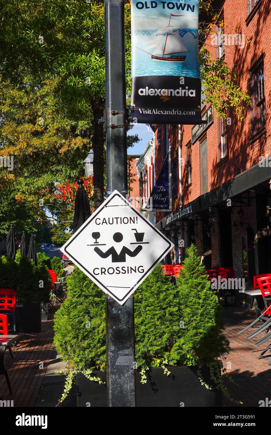 Caution "waiter crossing" sign, early autumn morning in outdoor seating ...