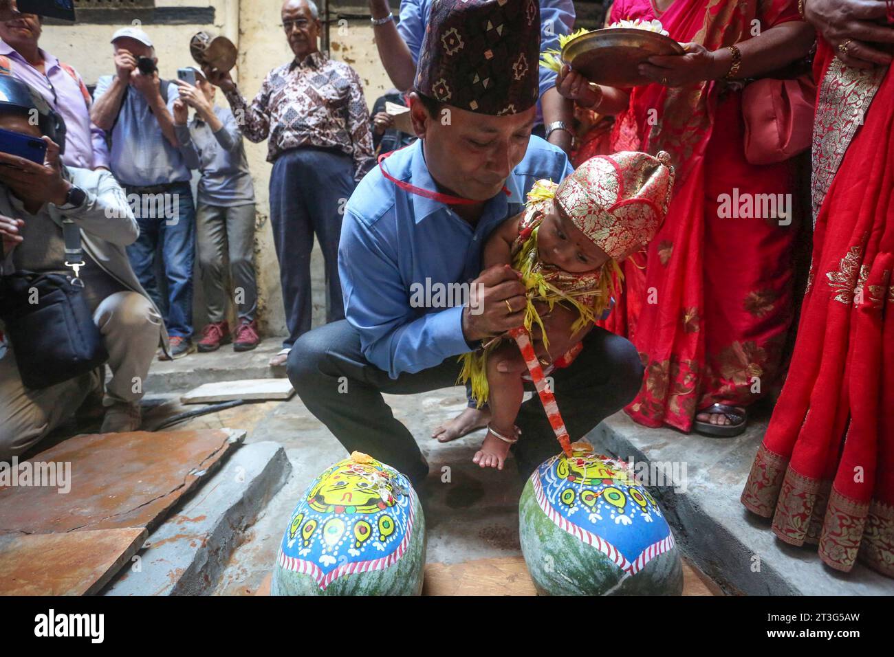 Kathmandu, Bagmati, Nepal. 25th Oct, 2023. A small kid cuts ash gourds ...