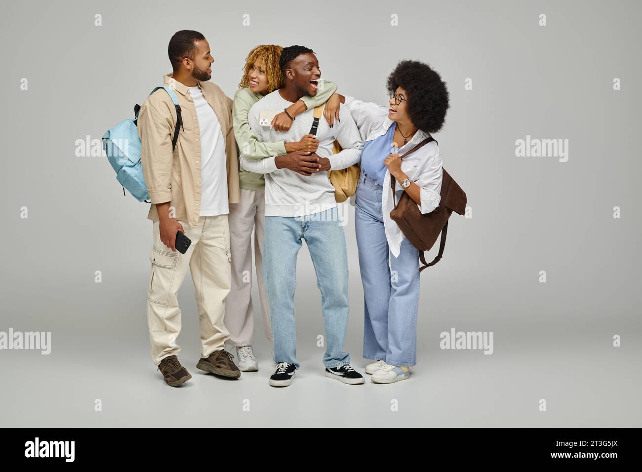 cheerful african american friends hugging warmly and smiling at each ...