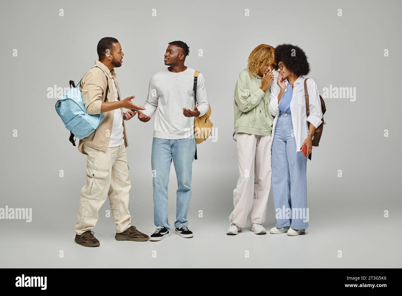 young women whispering secretly to each other next to their male ...