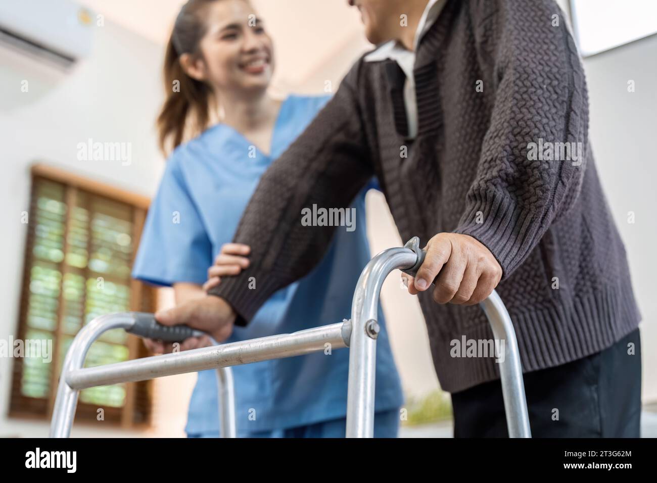 caregiver or nurse help support elderly are standing up without walker ...