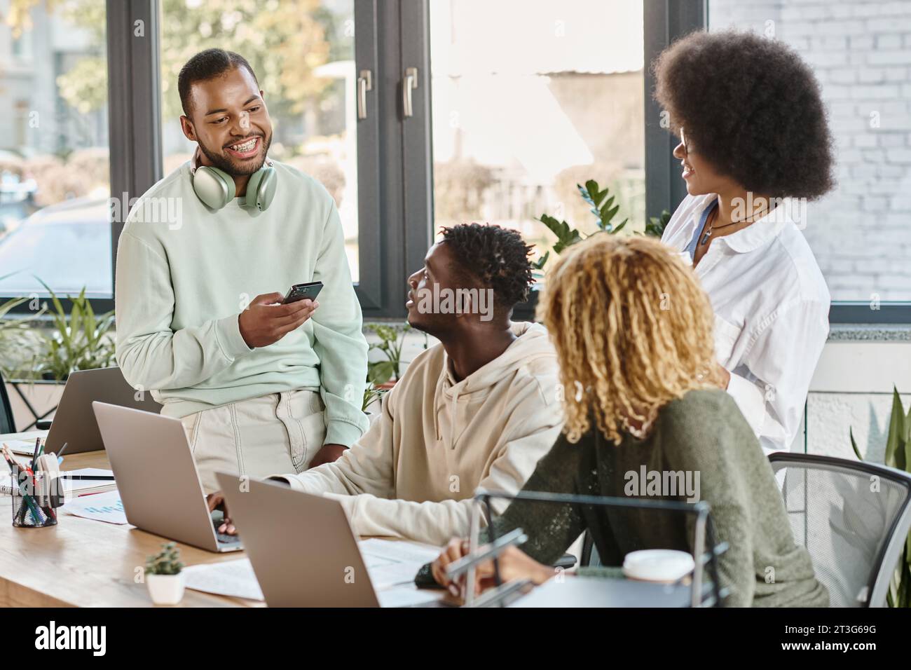 three good looking people looking attentively at their smiling friend ...