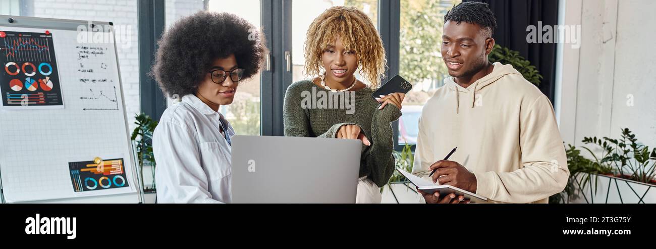 team of young friends working on their project with graphics on ...