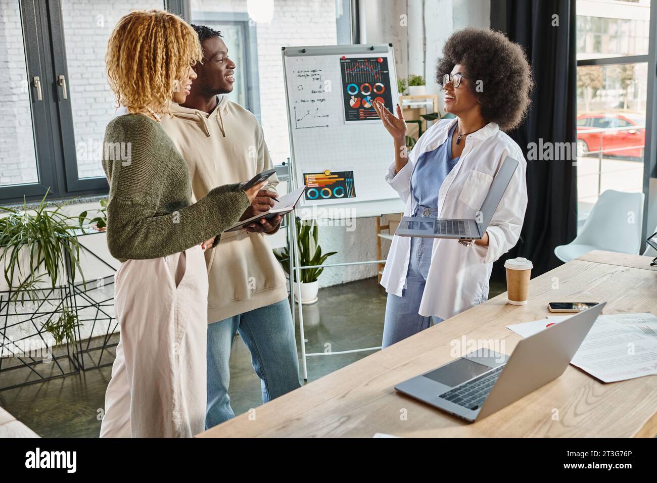 good looking friends discasing actively their project and smiling at ...