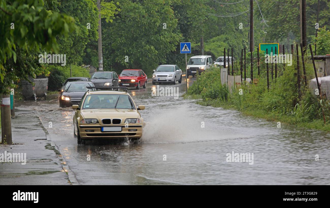 Car Driving Through Flooded Street Natural Disaster Stock Photo - Alamy