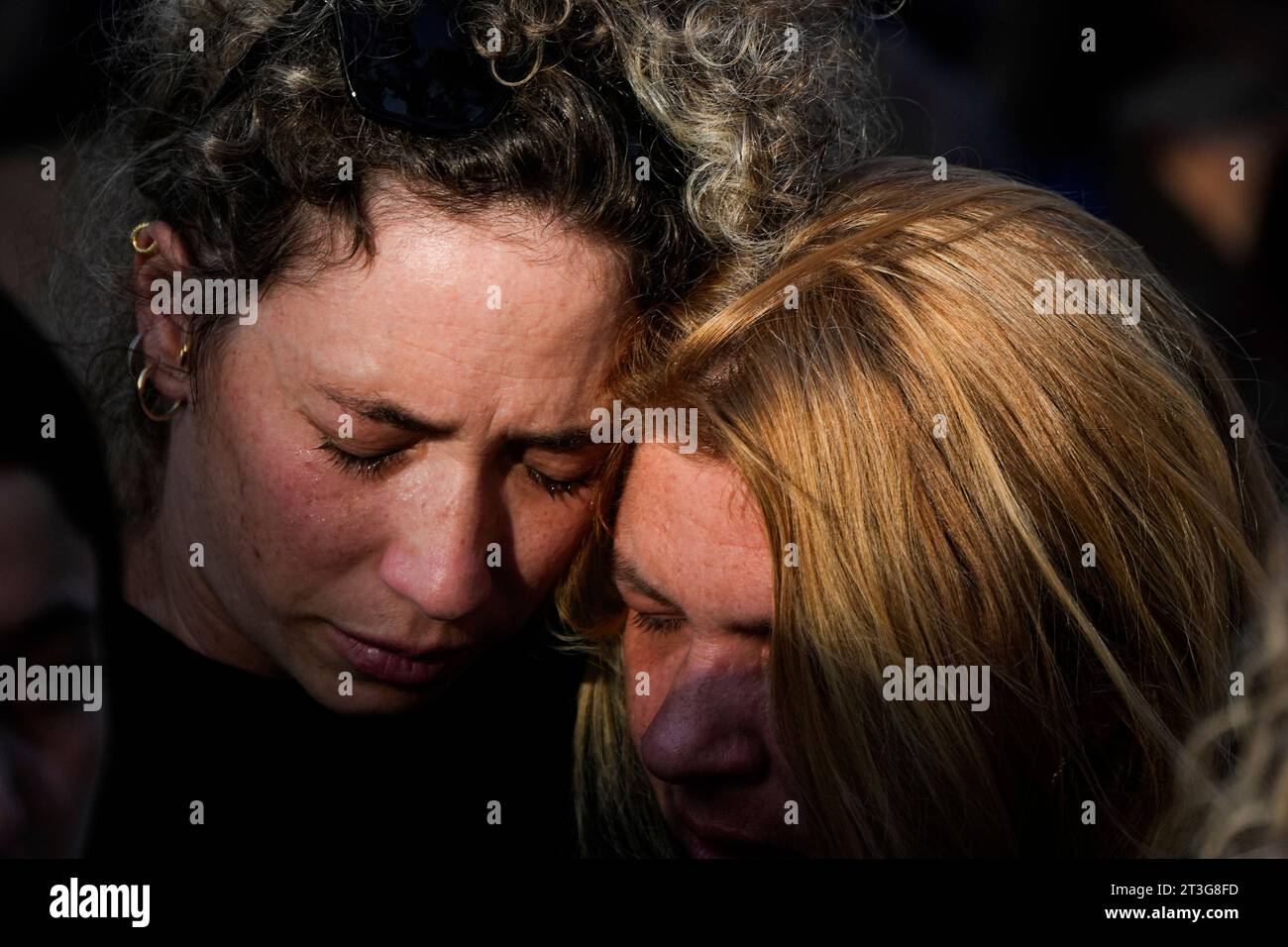 Mourners gather around the graves of British-Israelis Lianne Sharabi ...