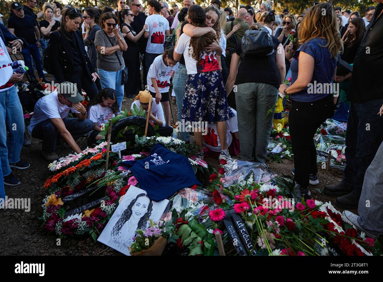 Mourners gather around the graves of British-Israelis Lianne Sharabi ...