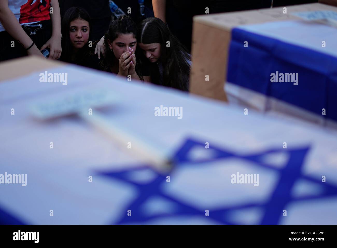 Mourners gather around the coffins of British-Israelis Lianne Sharabi ...