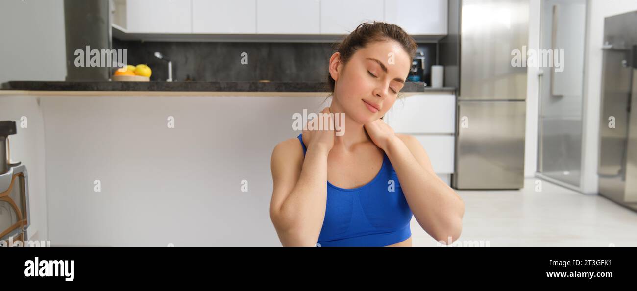 Portrait of woman workout from home, does training exercises, stretches ...