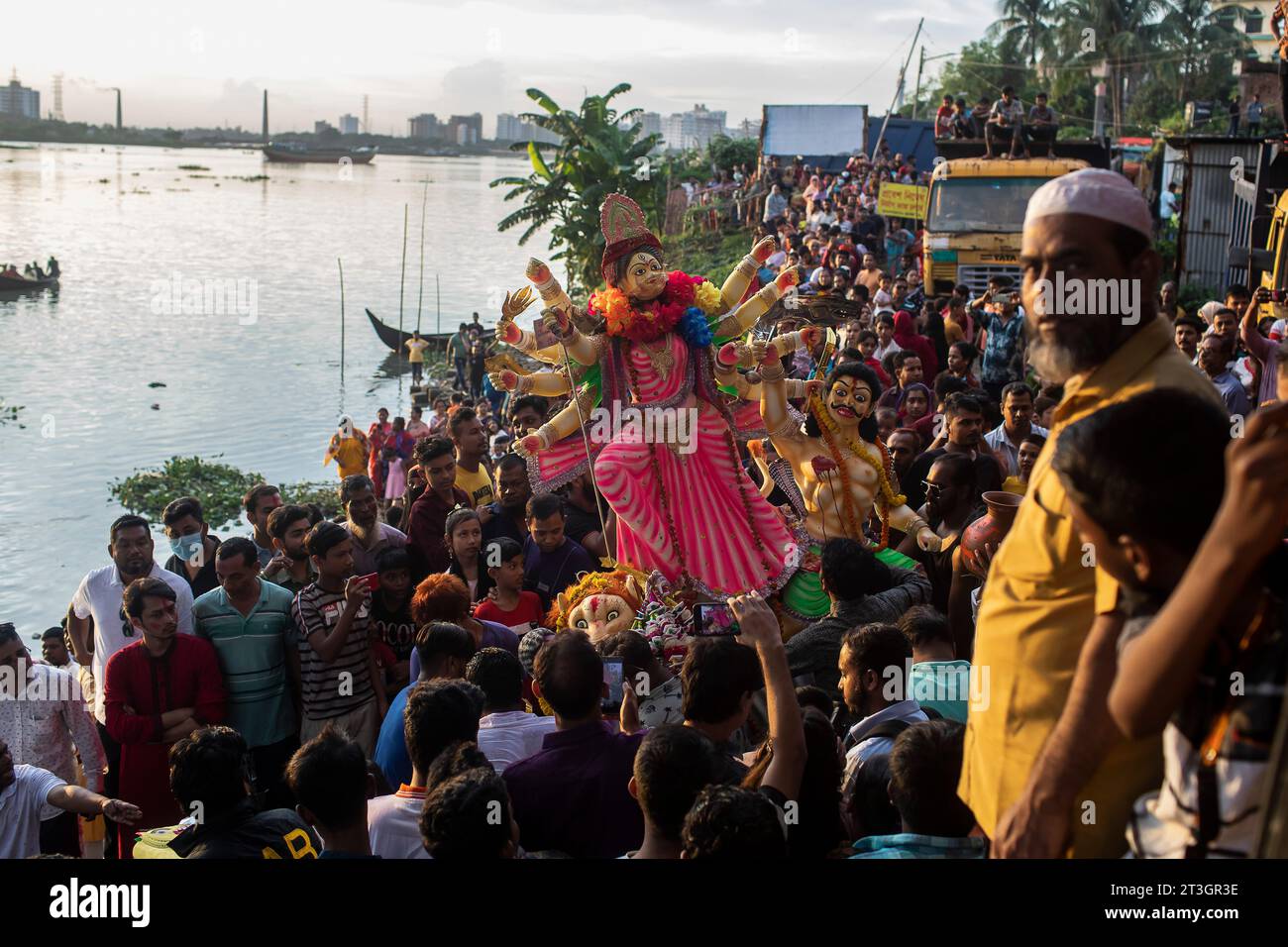 Dhaka, Bangladesh. 24th Oct, 2023. Hindu devotees immerse a clay idol ...