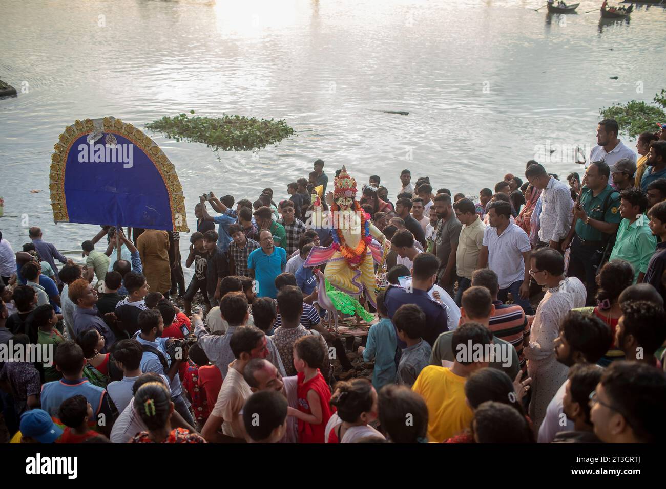 Dhaka, Bangladesh. 24th Oct, 2023. Hindu devotees immerse a clay idol ...