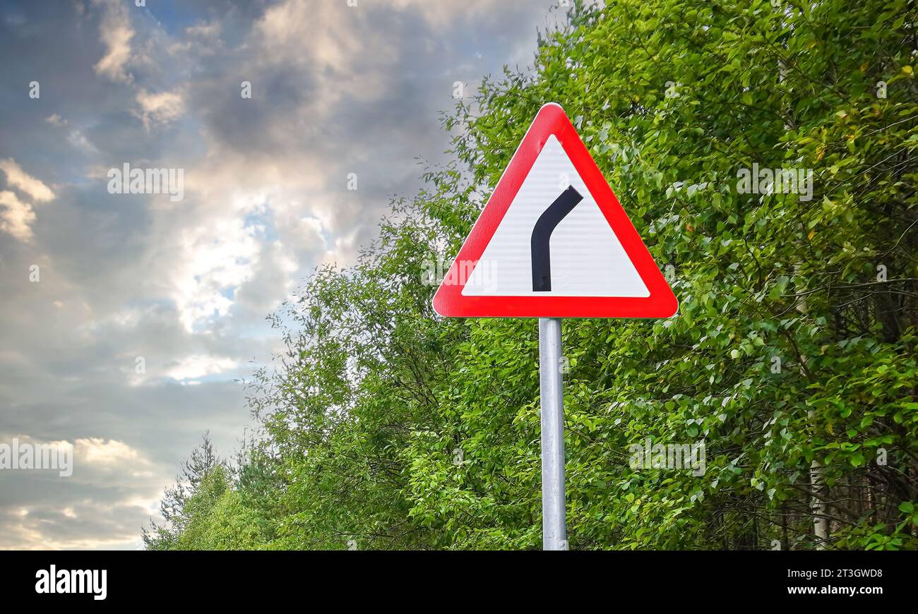 Warning road sign for abrupt turn and turn of the road Stock Photo - Alamy