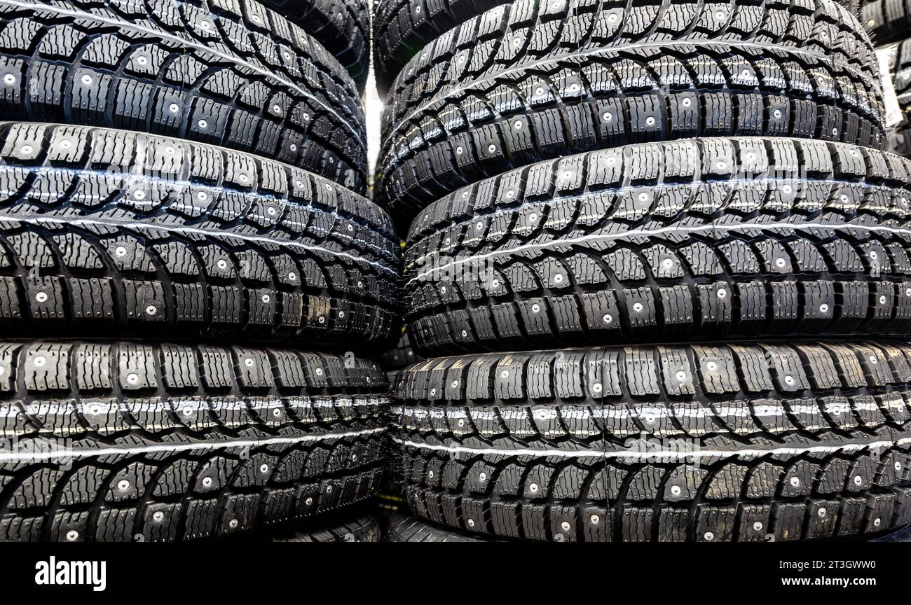 Winter tires stacked up for sale in the superstore. New winter studded ...