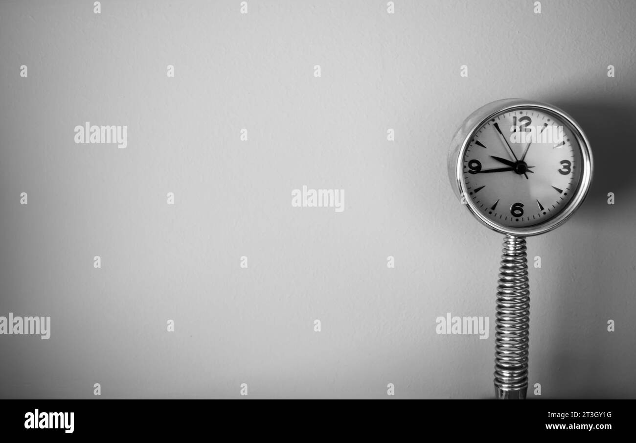 View of a table clock against white background Stock Photo - Alamy
