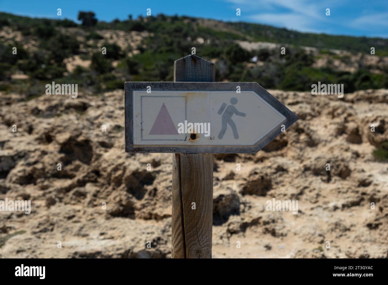 Metal old rusty sign with hiking symbol on wooden pole at Gavdos island ...