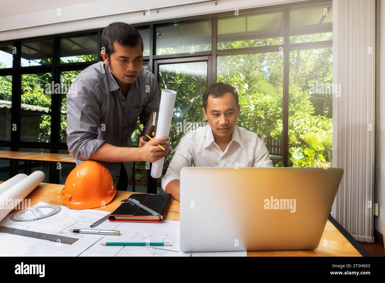 Confident team of architect working together in a office.They discussing about new startup ...
