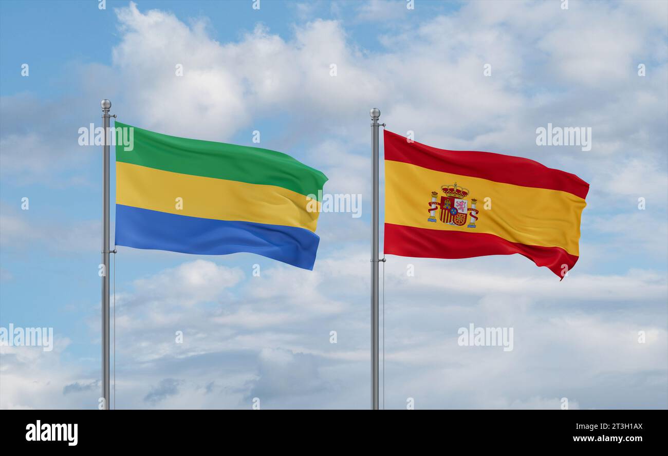 Spain and Gabon flags waving together in the wind on blue cloudy sky, two country relationship ...