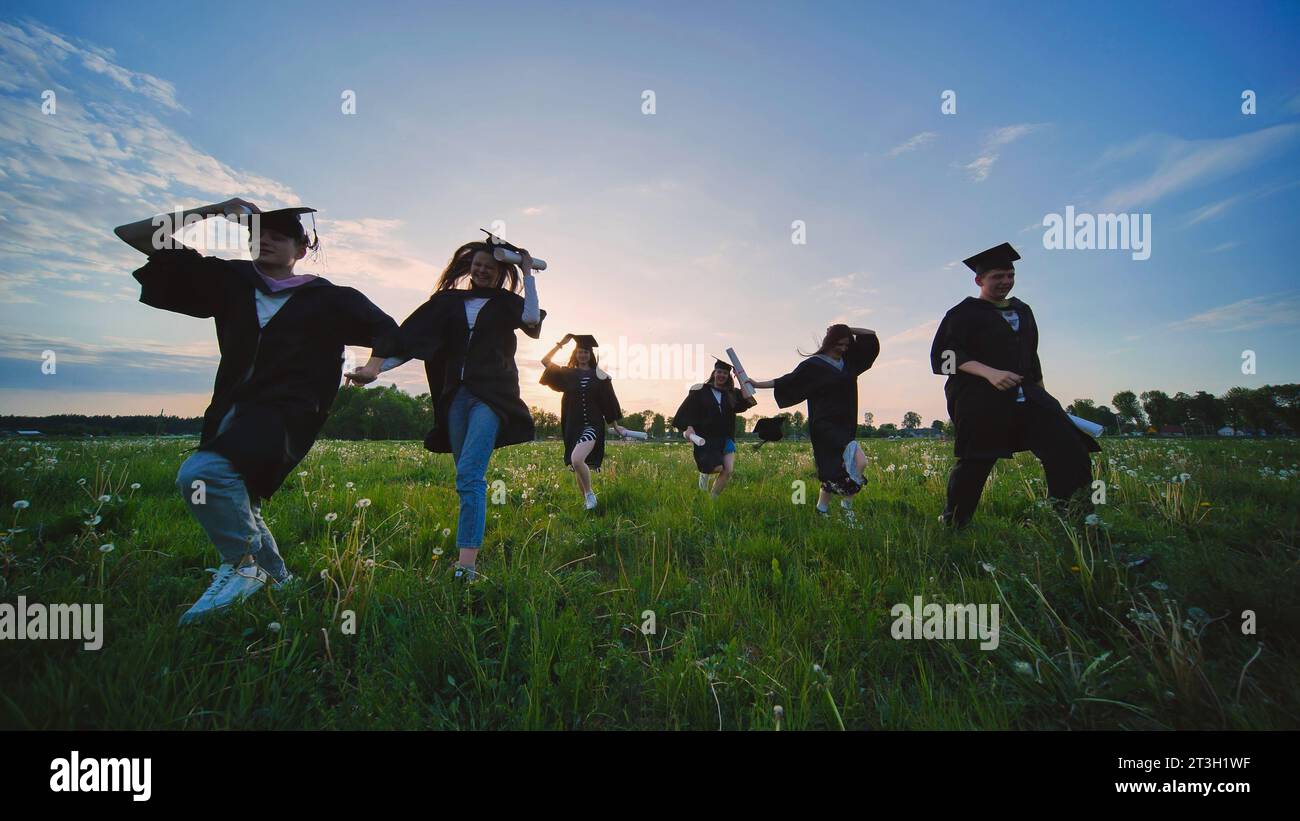University graduates running hi-res stock photography and images - Alamy