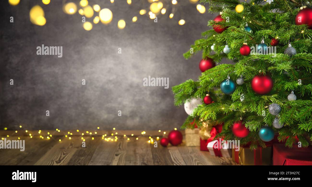 Delightful Christmas tree closeup with textured gray wall as a nice ...