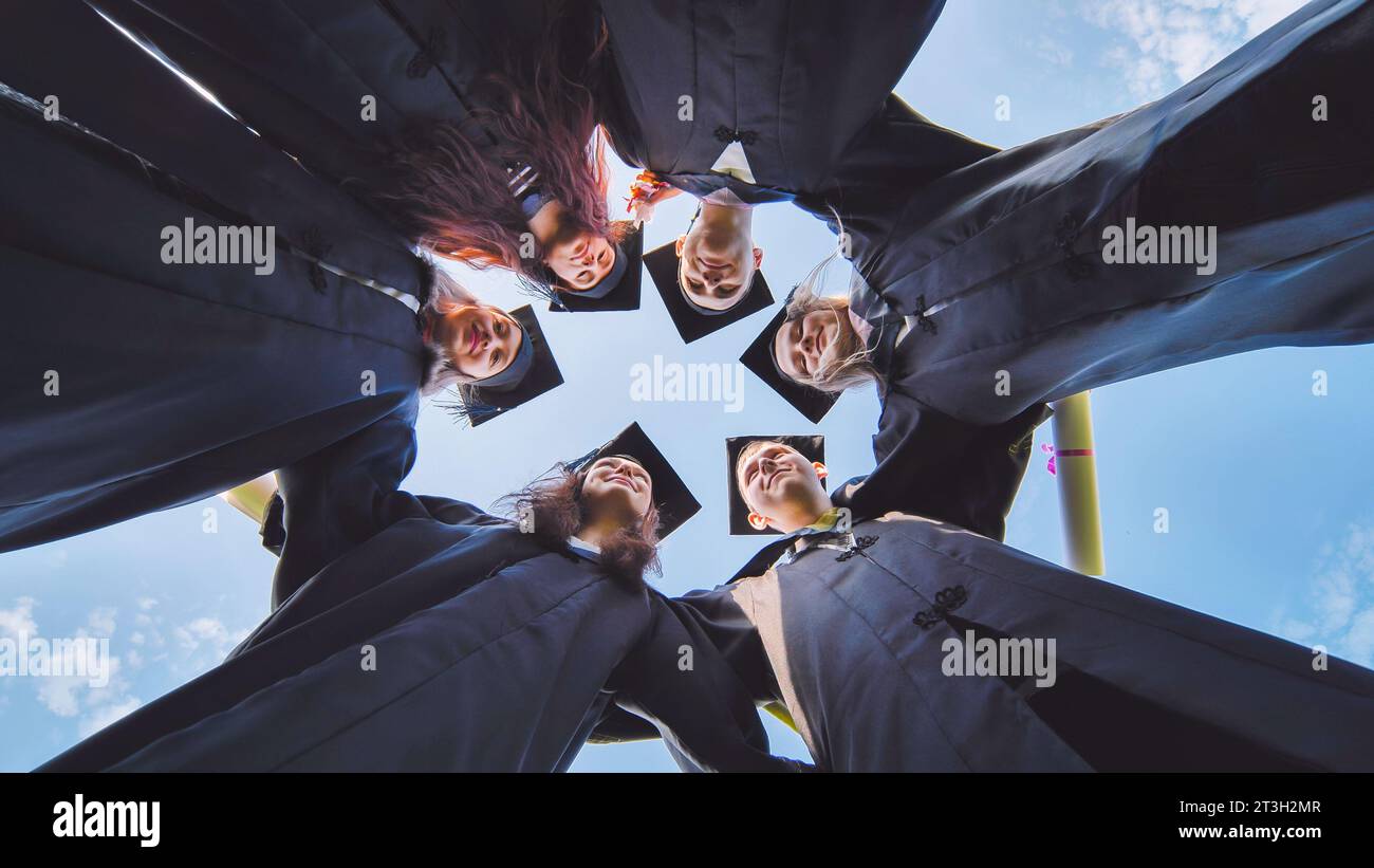 College graduates embrace in a circle Stock Photo - Alamy