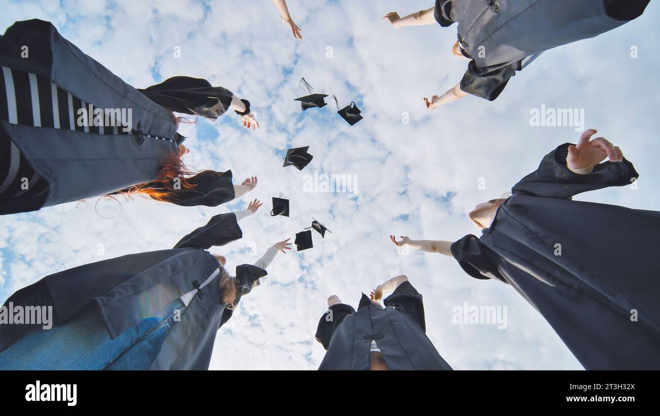 Graduating students hands throwing graduation caps in the air Stock ...