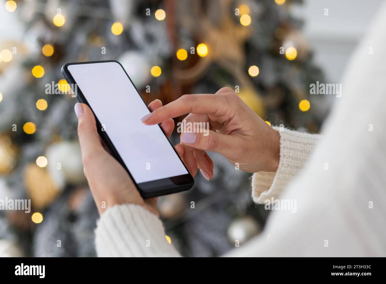 Close-up photo of young female hands holding and using a mobile phone ...