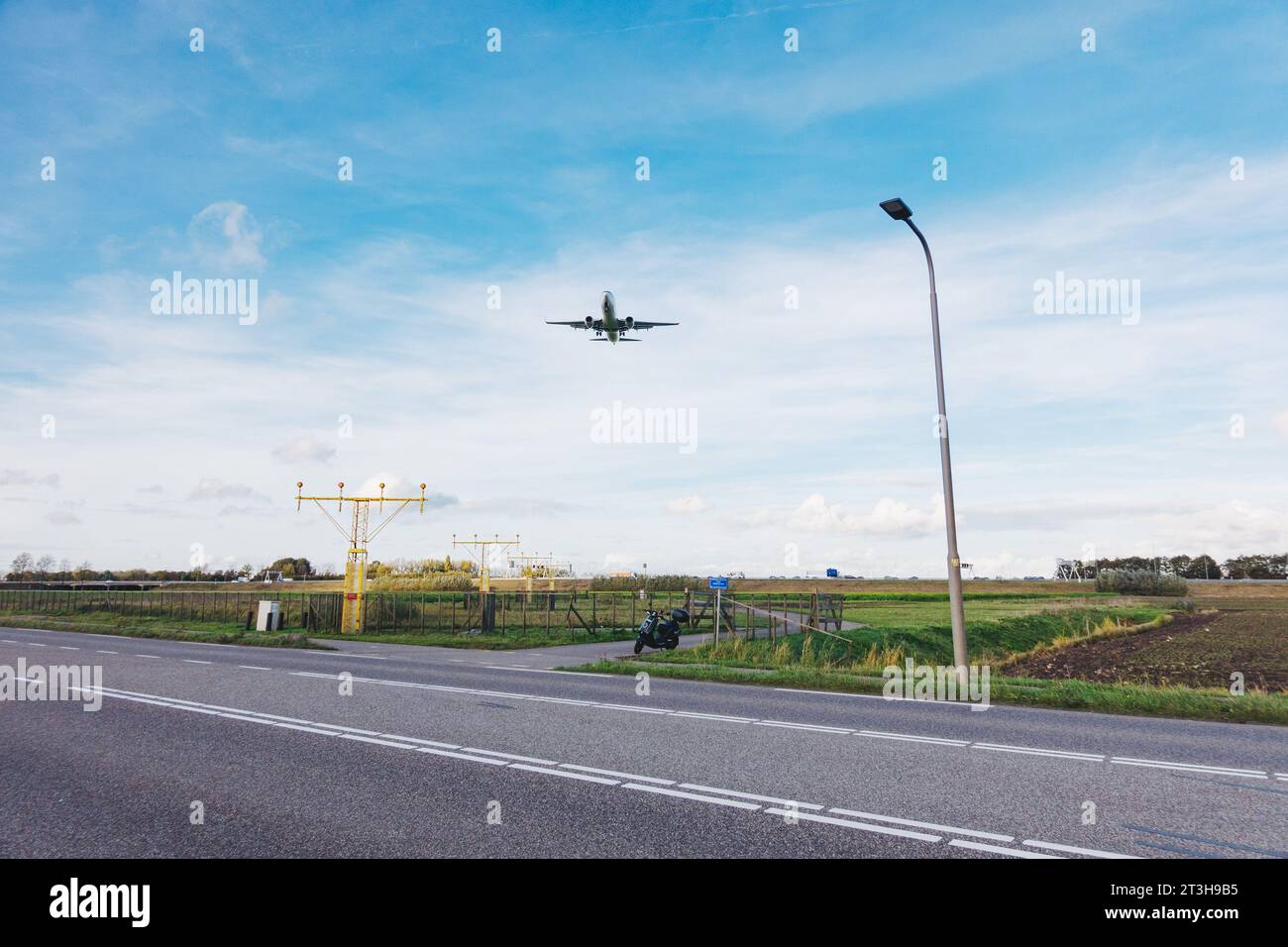 a Boeing 737 jet flies over approach lights landing on Amsterdam ...