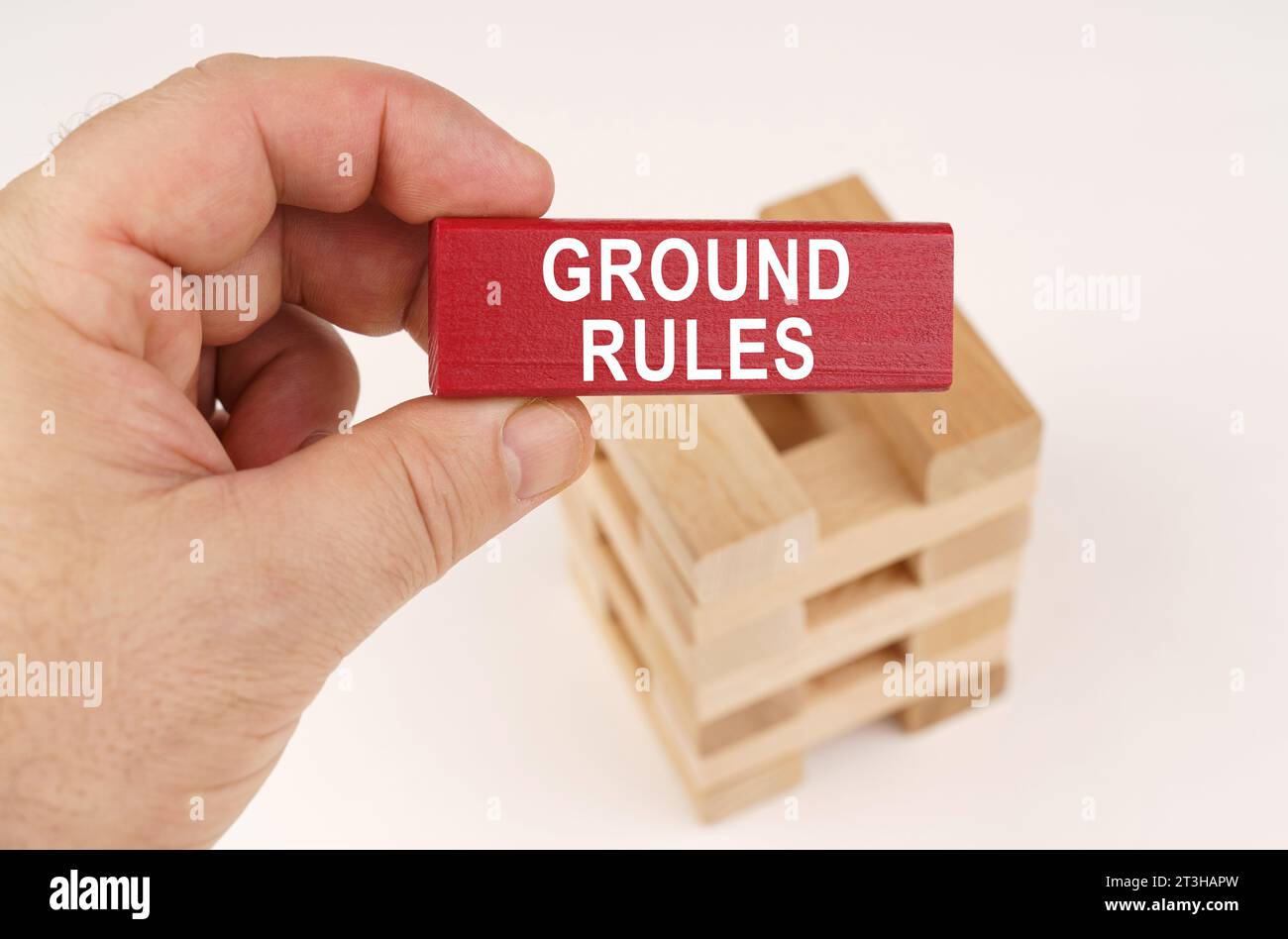 Business concept. In the hands of a man there is a red wooden plate ...