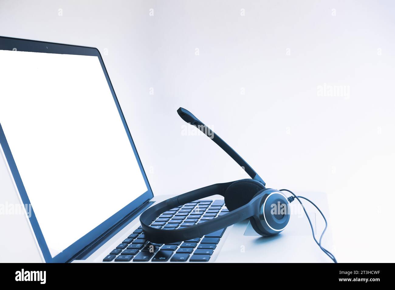 black video conference headset on top of a computer keyboard with white ...